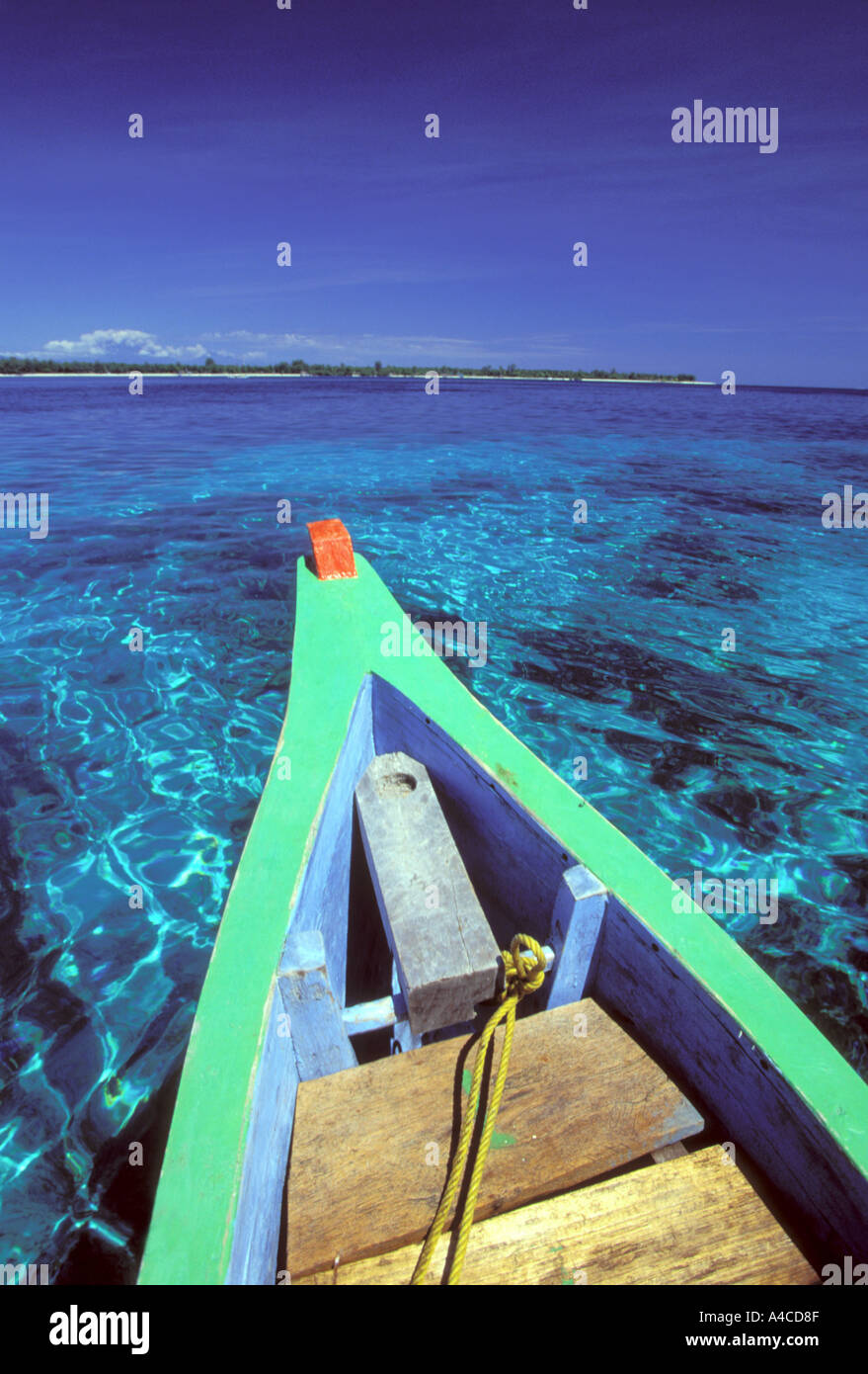 Bow of fishing boat seen anchored over clear tropical water Lombok ...