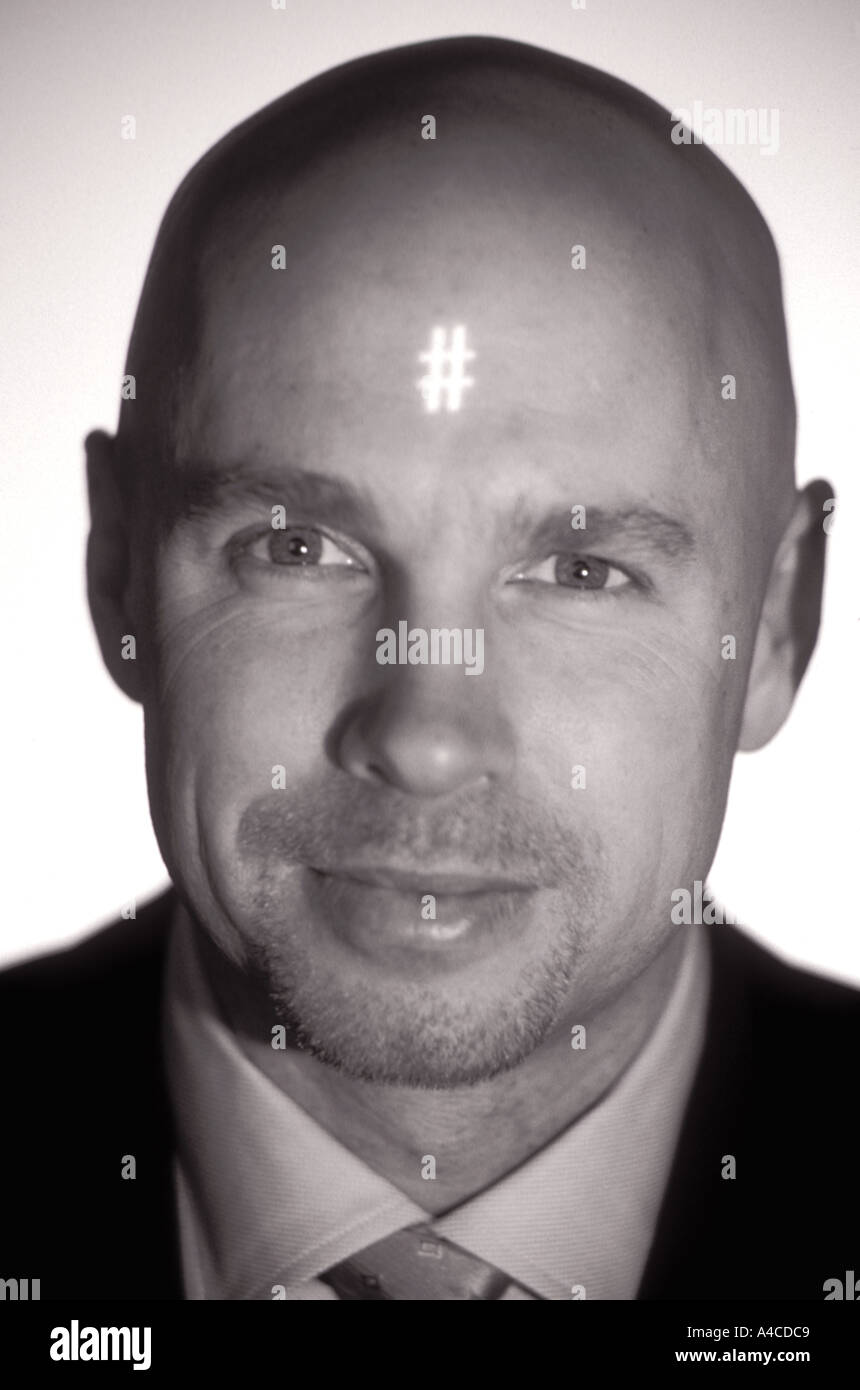 Bald businessman with number symbol projected on his forehead Stock ...