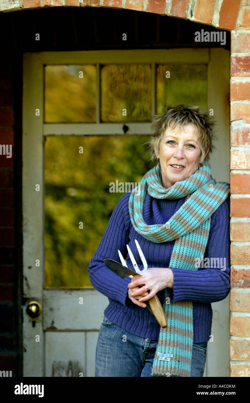 portrait of TV gardener Carol Klein relaxing in garden at home in Devon ...