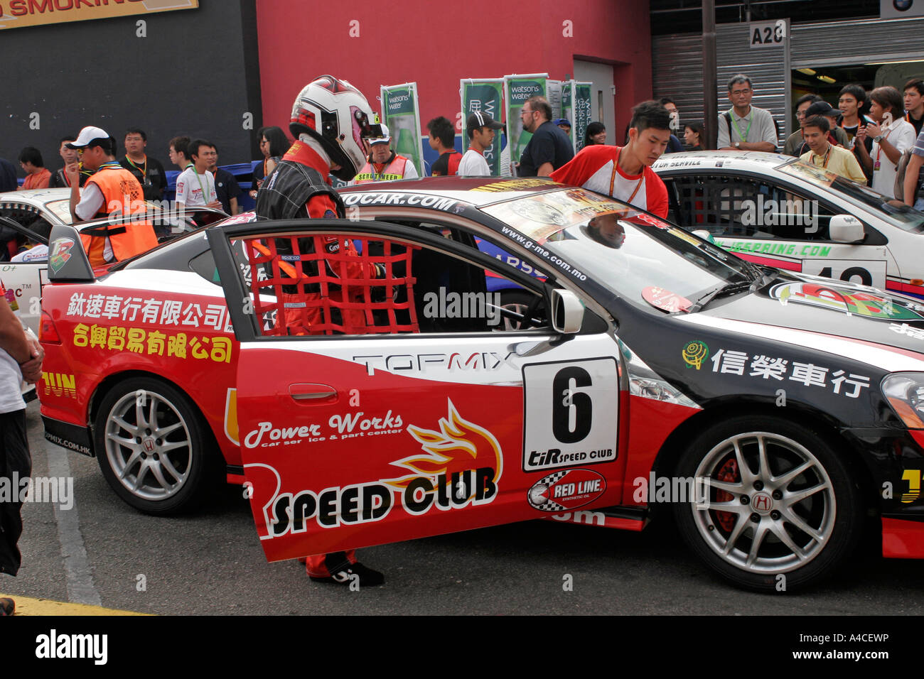 Driver enters car for start of Silver Jubilee Cup Race at Macau Grand ...