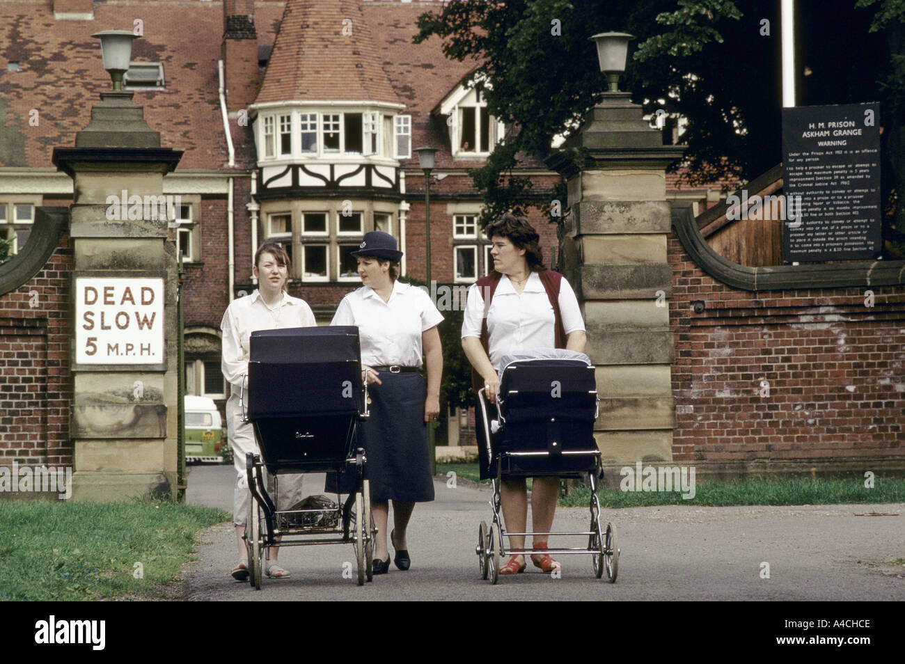 Here a prison officer accompanies two mothers and their babies in their ...