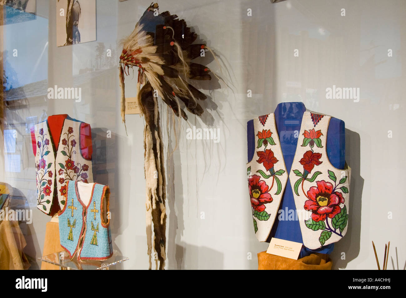 North American Indian beadwork vests and a war bonnet, on display at a ...