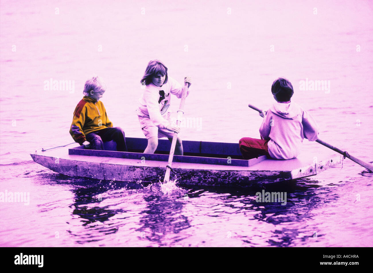 Kids playing on raft Stock Photo - Alamy