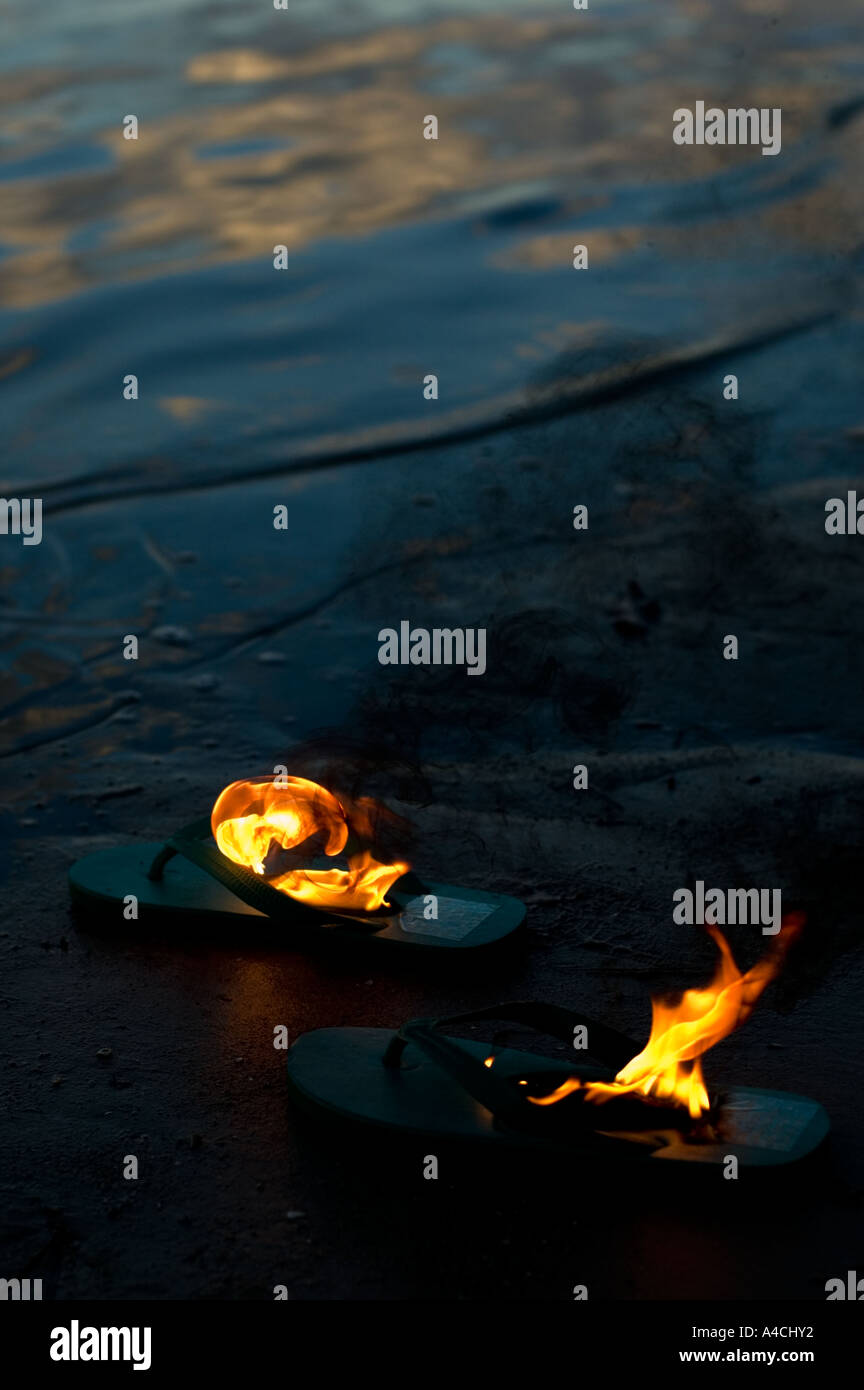 Photographer setting fire to thongs Stock Photo - Alamy