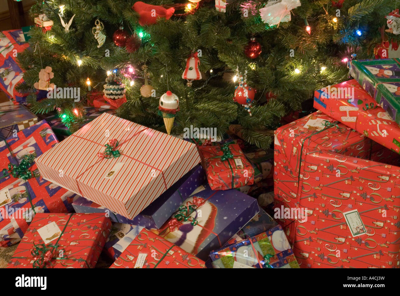 Christmas presents under a decorated tree Stock Photo - Alamy