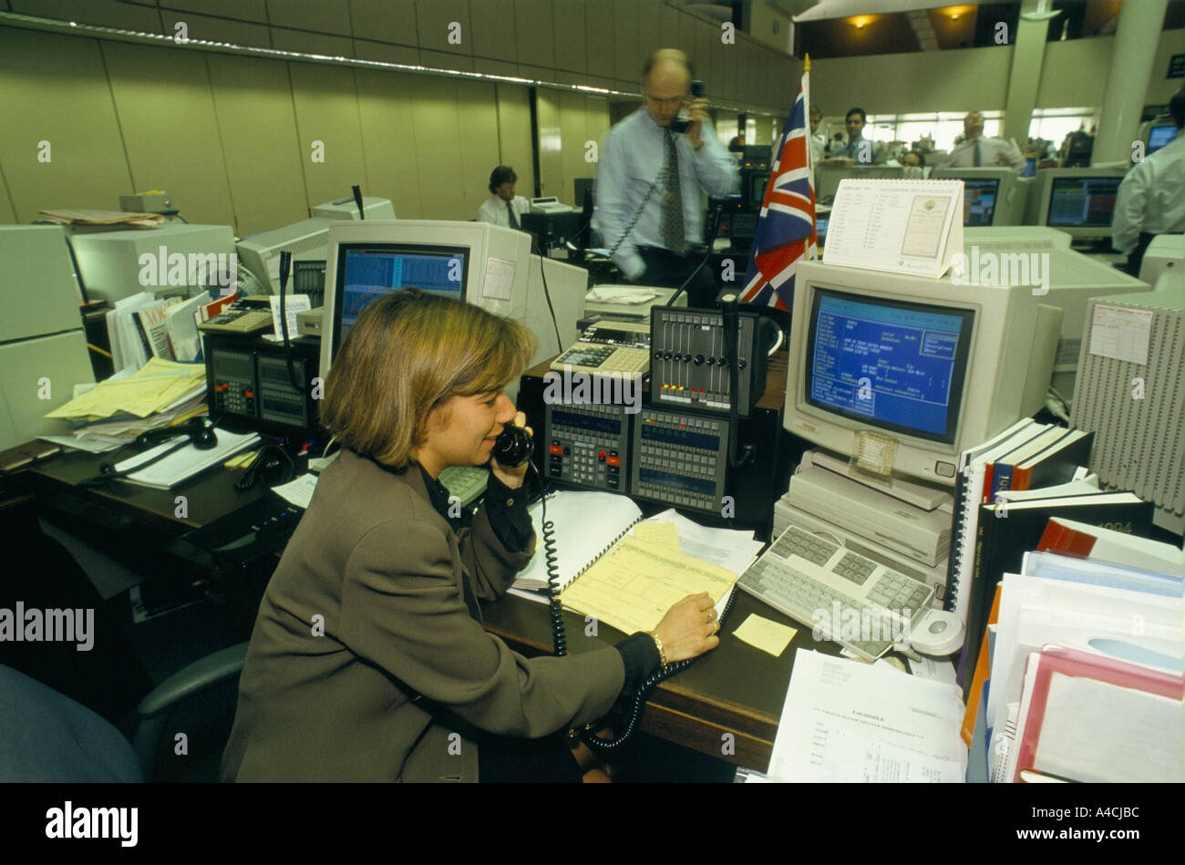 trading floor london 1994 a female broker talks on telephone in front ...