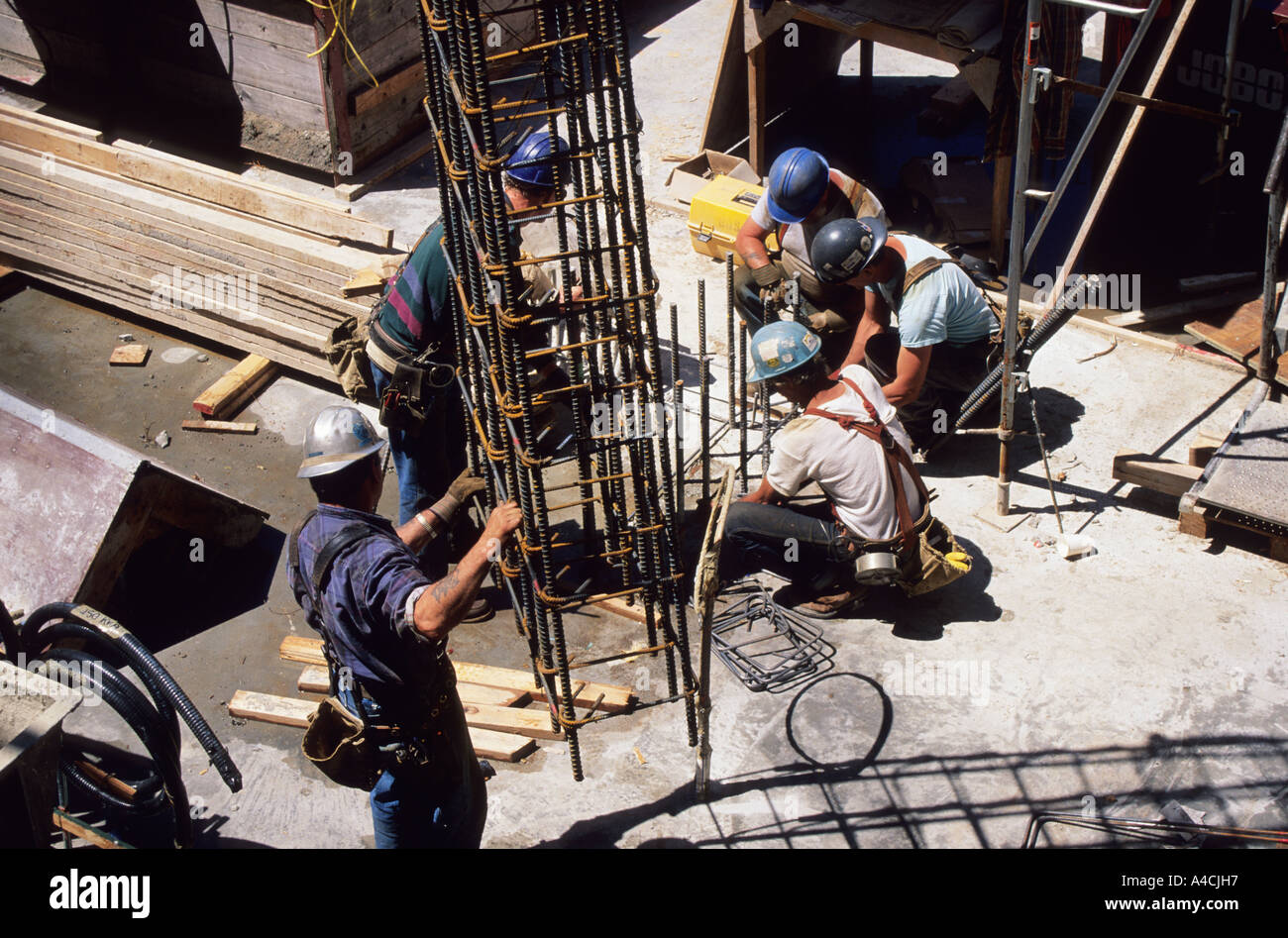 Construction workers assembling rebar frame Stock Photo - Alamy