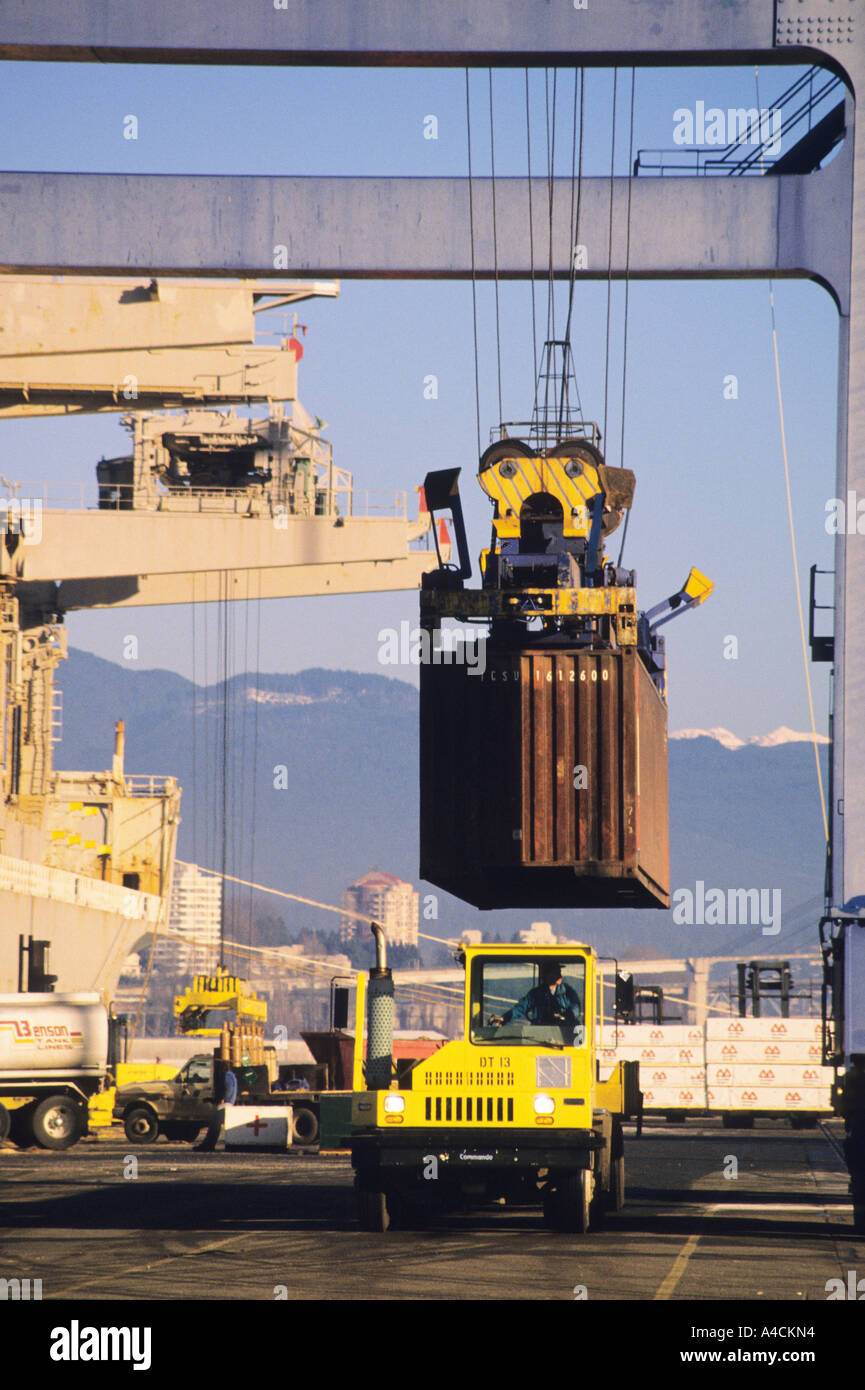 Truck moving shipping containers into position for loading Stock Photo ...