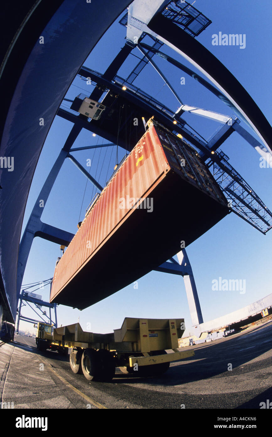 Loading shipping containers onto freighter Stock Photo - Alamy