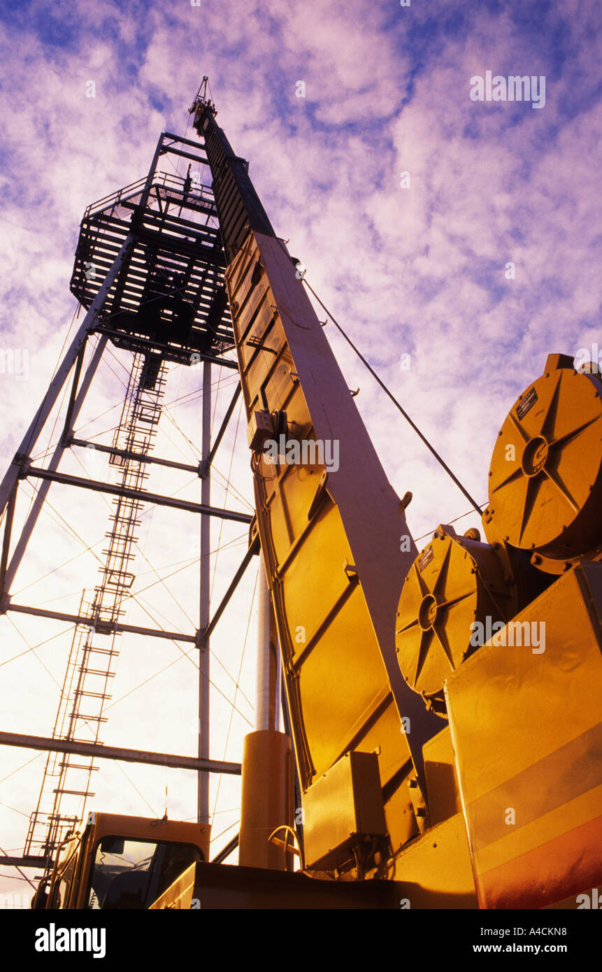 Construction crane loading materials onto tower Stock Photo - Alamy