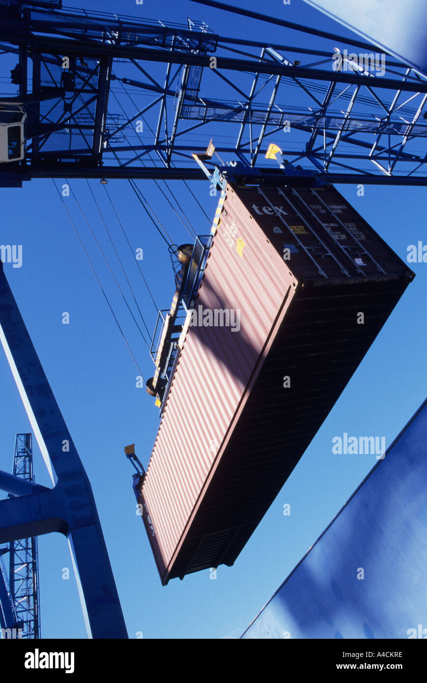 Loading container onto freighter Stock Photo - Alamy