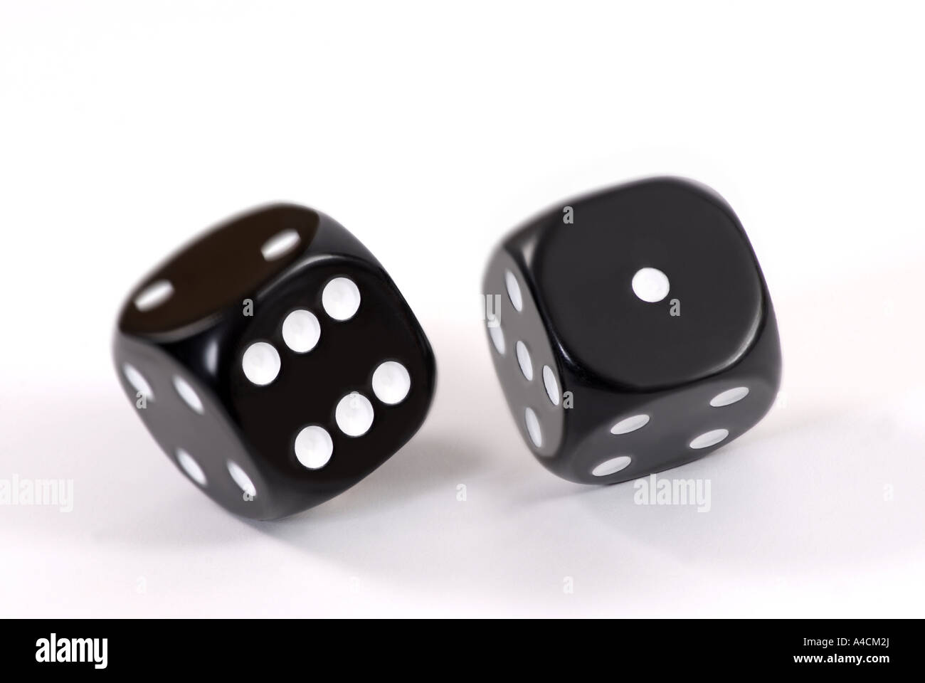 Pair of rolling black dice Stock Photo - Alamy
