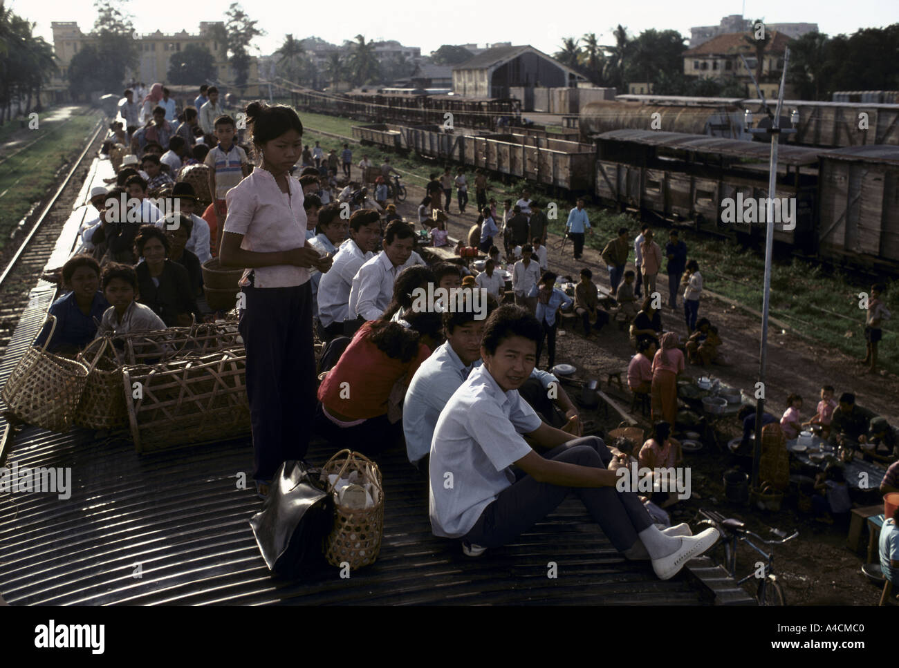 Passengers at the rail station in Phnom Penh sit onto the roof of this ...
