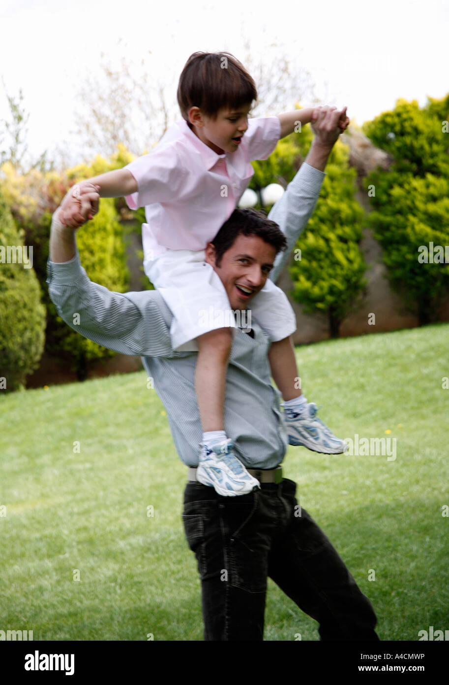 Man carrying a little boy on his shoulders Stock Photo - Alamy