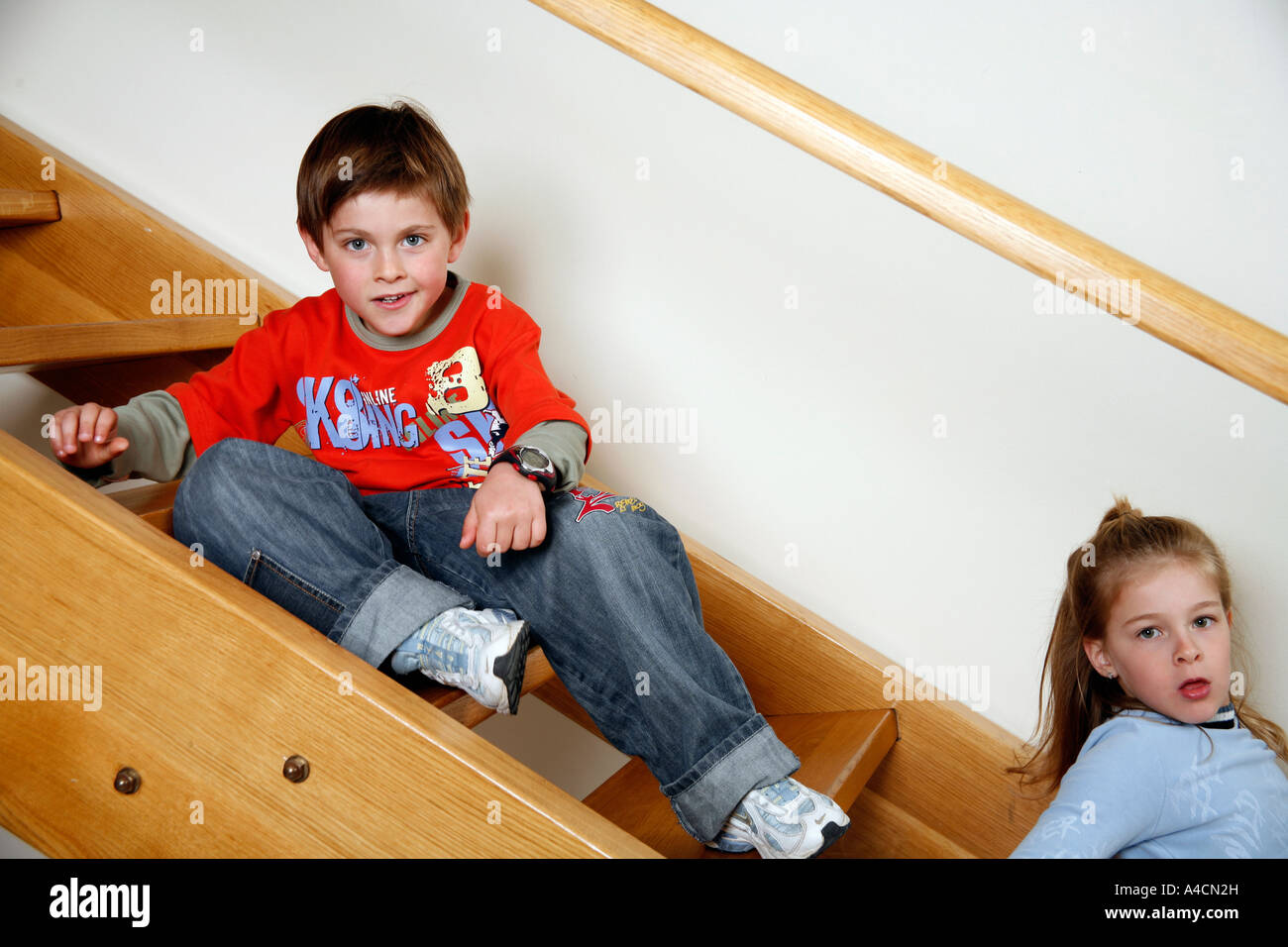 Tired children on staircase Stock Photo - Alamy
