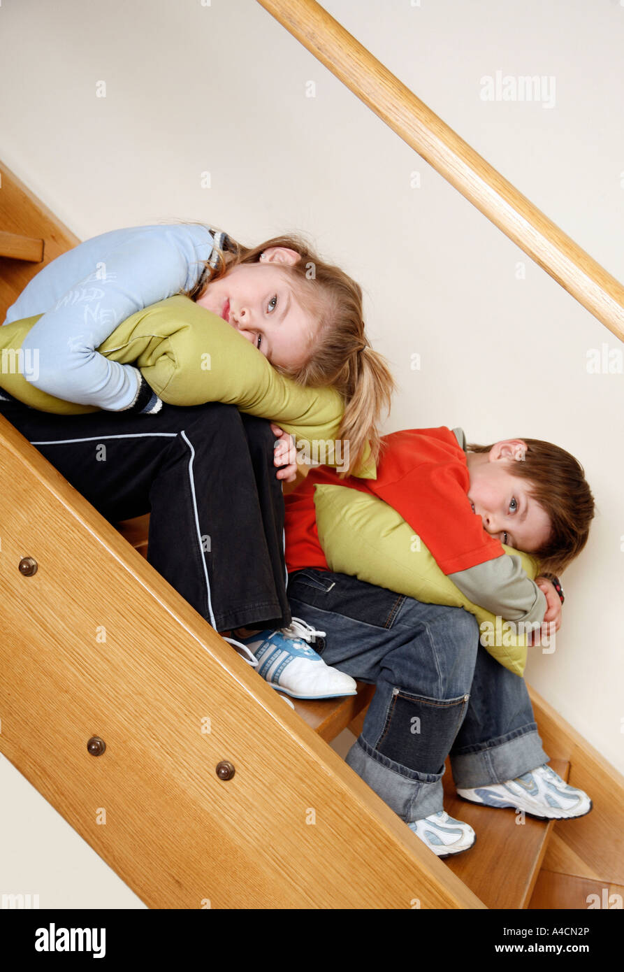 Tired children on staircase Stock Photo - Alamy