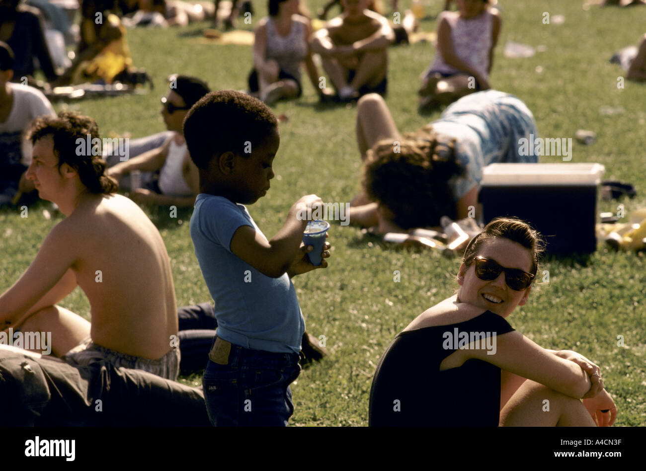 YOUNG BOY EATING ICE-CREAM AT A ROCK CONCERT IN BATTERSEA PARK, LONDON ...