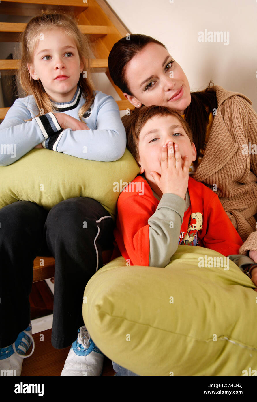 Mother with tired children on staircase Stock Photo - Alamy