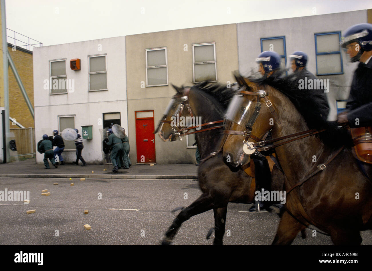 POLICE RIDE THEIR HORSES THROUGH MOCKED-UP STREETS WITH OTHER POLICEMEN ...