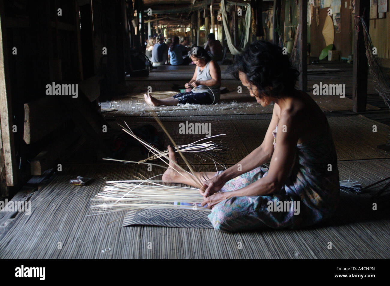 Iban people plaiting bamboo handicraft in Lalang longhouse at Skrang ...