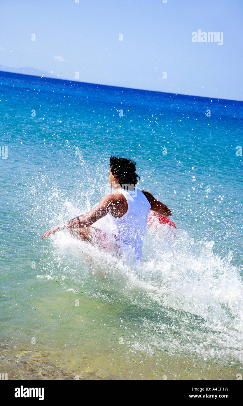 Young man beach alone splash swimming hi-res stock photography and ...