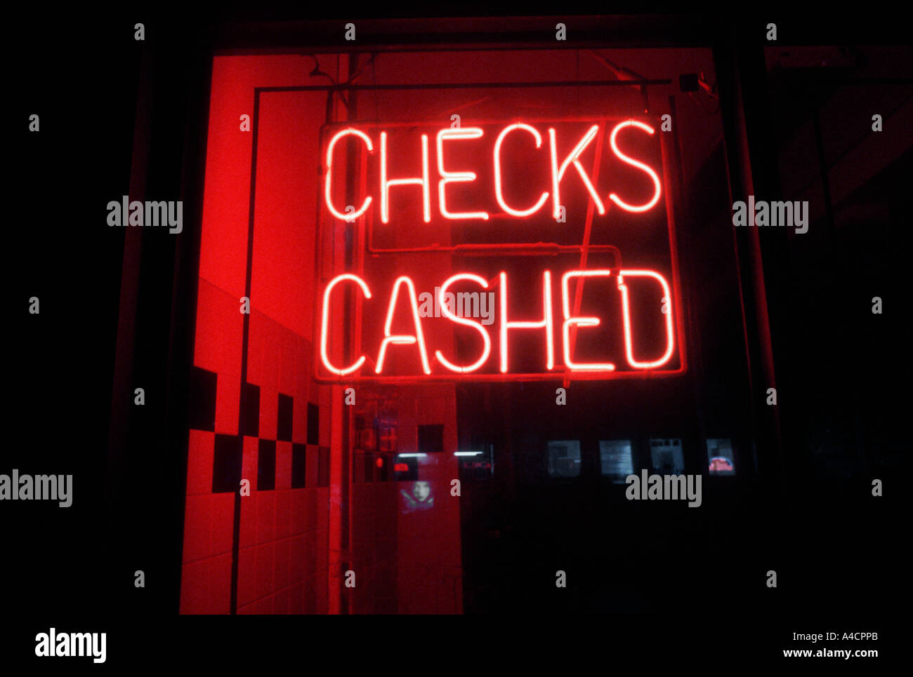 Check Cashing sign in window of closed shop Stock Photo - Alamy