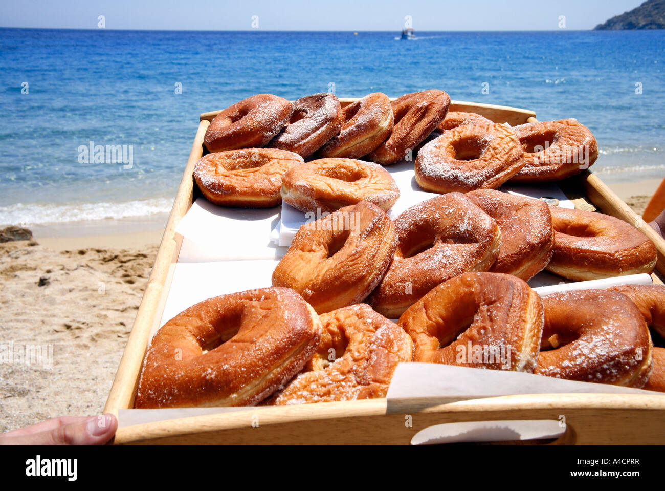 A tray of donuts on the beach Stock Photo - Alamy