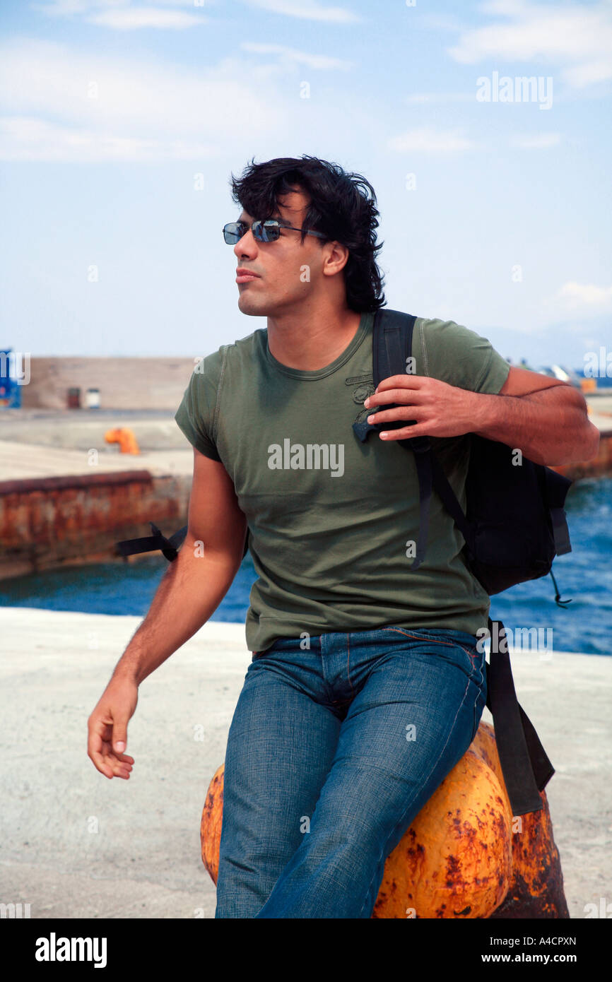 Young man waiting at ferry dock Stock Photo - Alamy