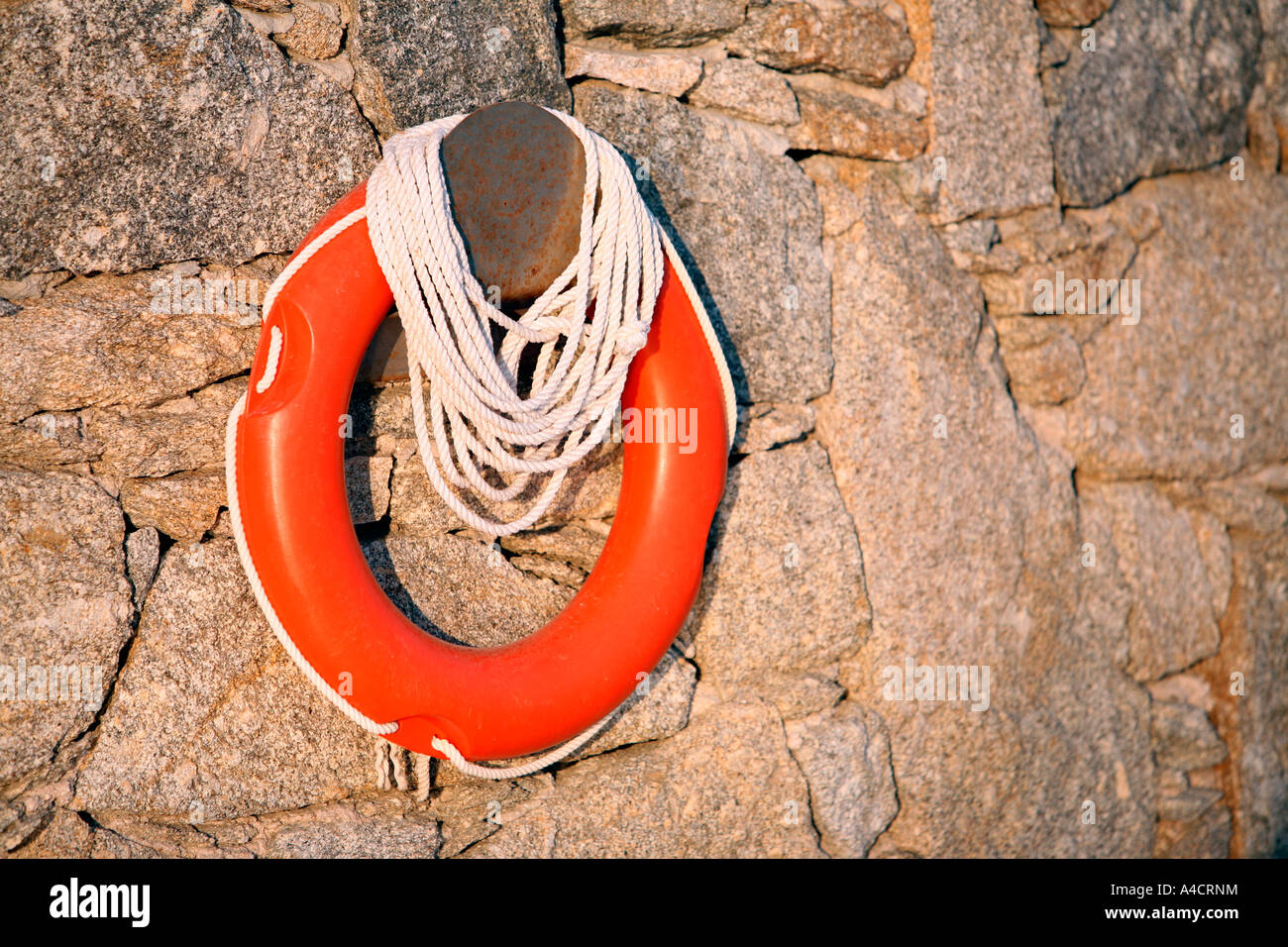 Life preserver on stone wall Stock Photo - Alamy