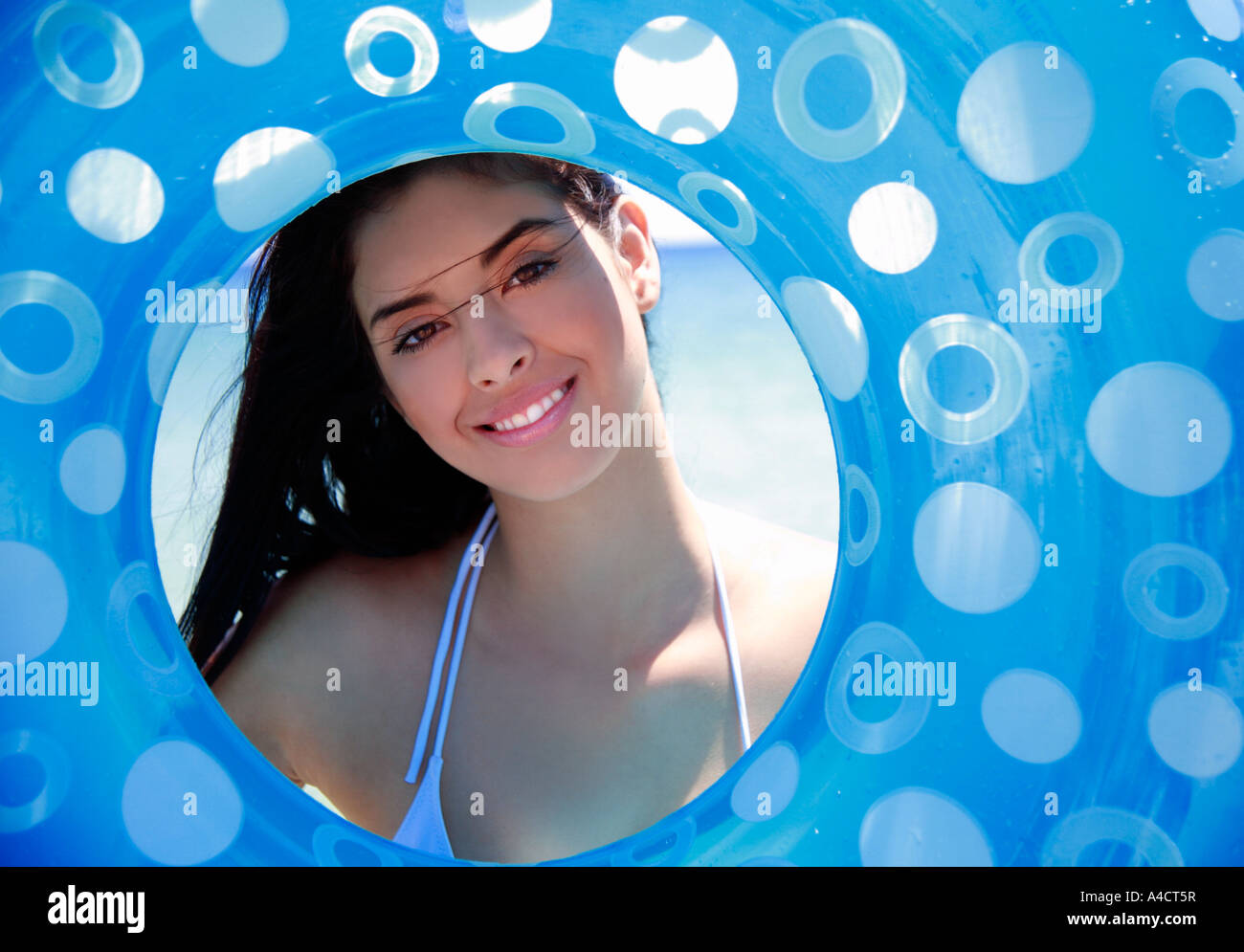 Young woman s face framed by inflatable life ring Stock Photo - Alamy
