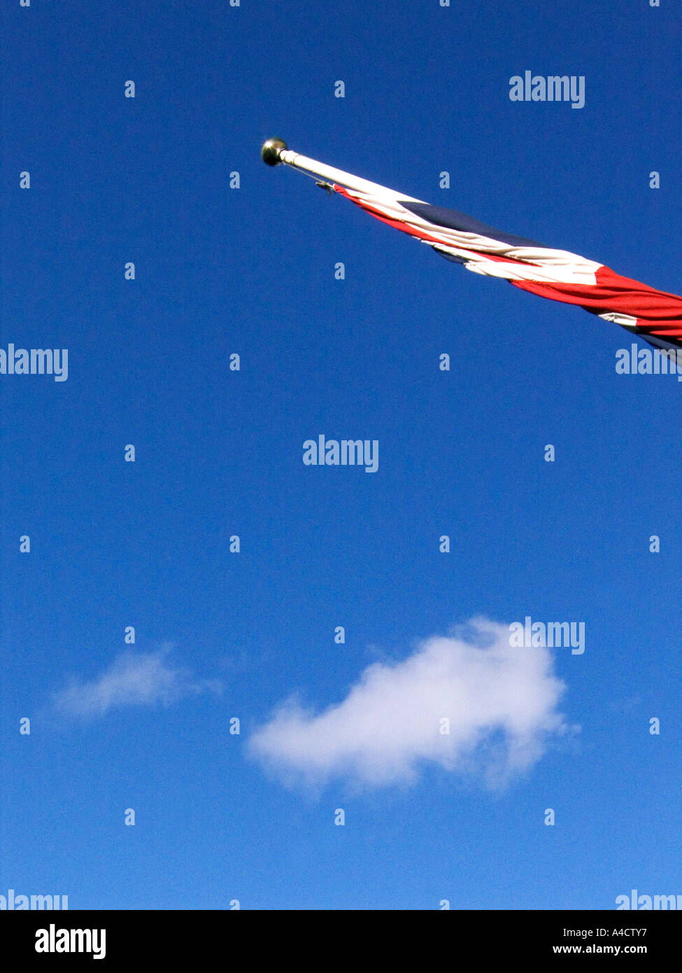 rolled up union jack flag with clouds Stock Photo - Alamy