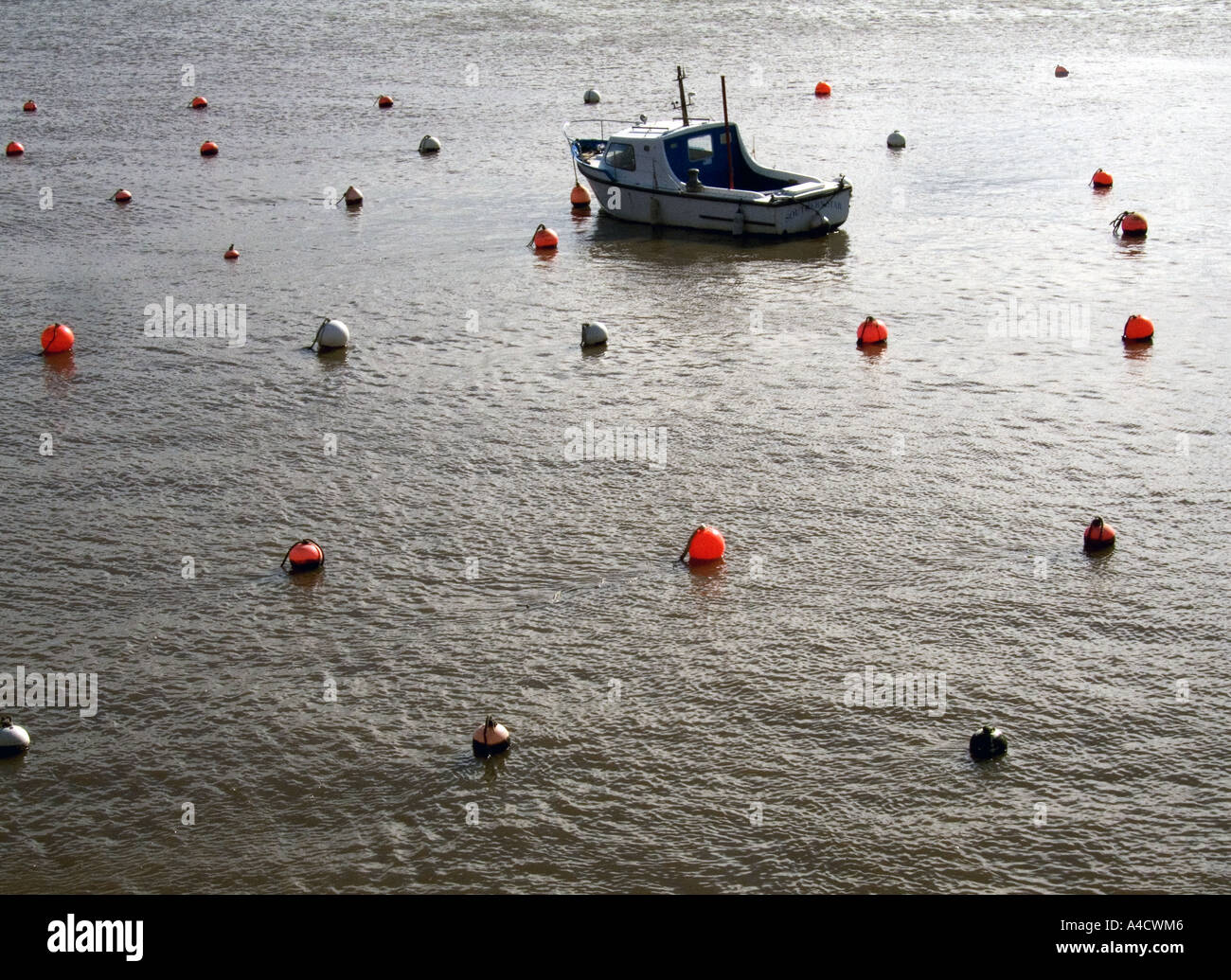 small boat anchored in harbour Stock Photo - Alamy