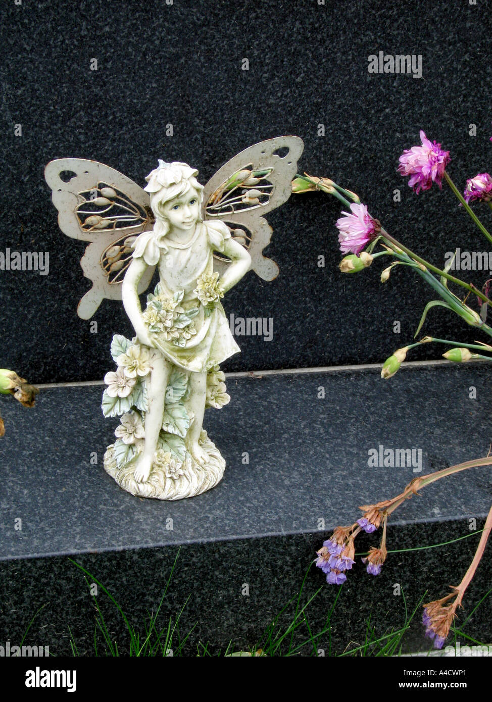 fairy figure standing on gravestone Stock Photo - Alamy