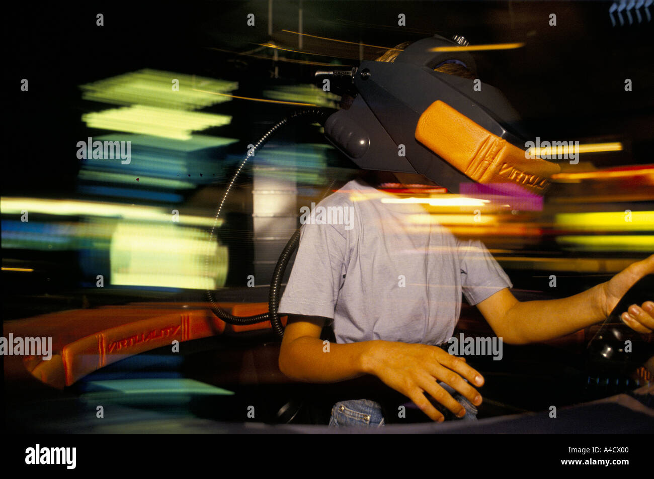 A girl wears a 3D visor to play a virtual reality video game in three ...