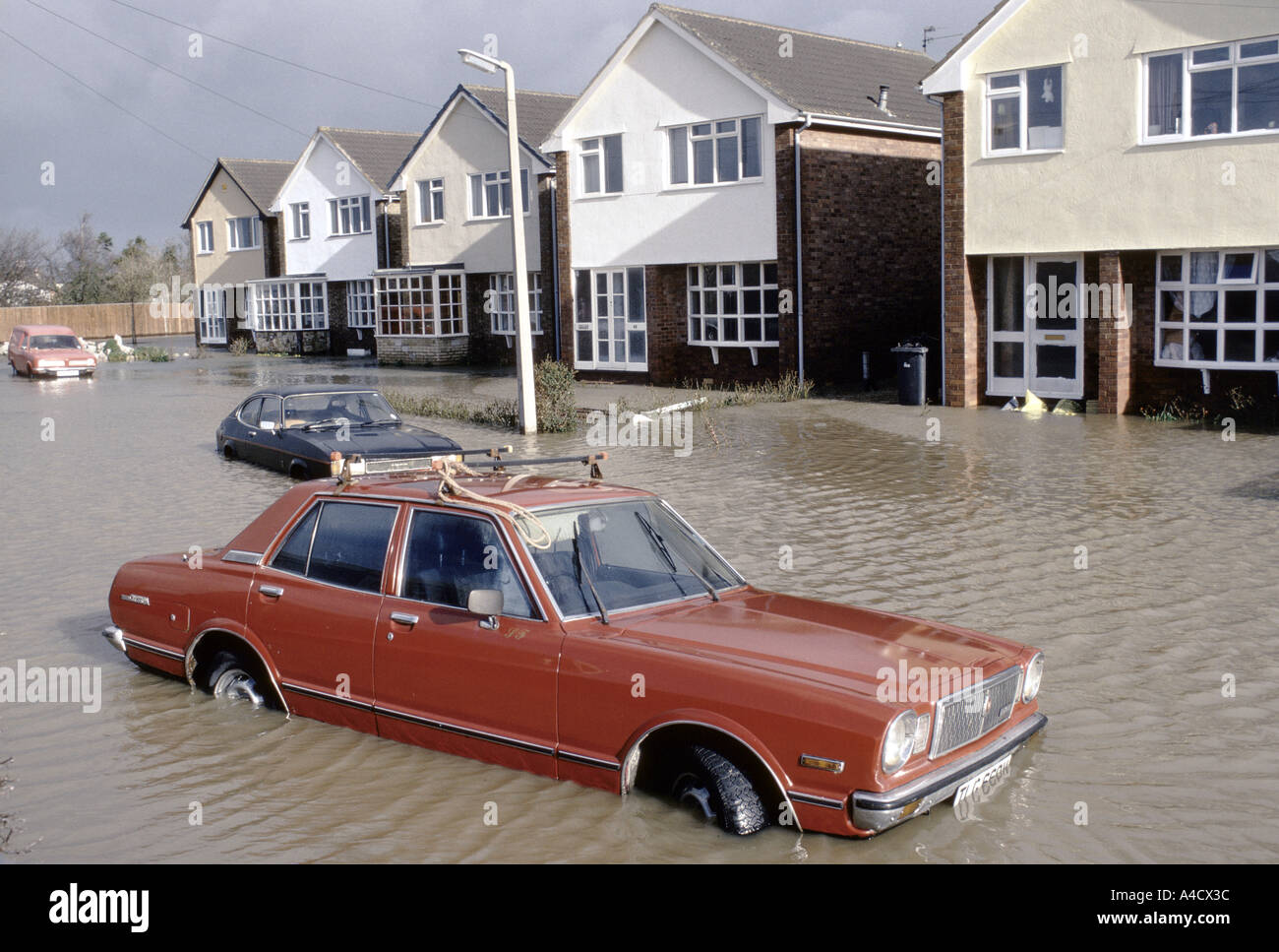 Waterlogged cars outside flooded houses after Hurricane winds cause the ...