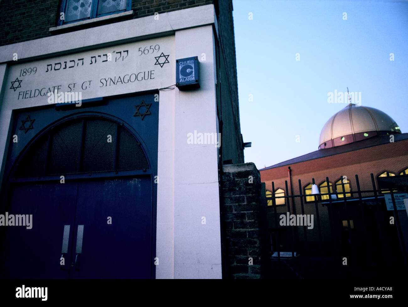 A synagogue and a mosque stand next to each other. Whitechapel, London ...