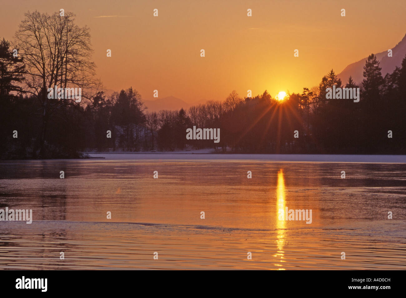 Sunrise at the lake Reintaler See near the town of Kramsach in Tyrol ...