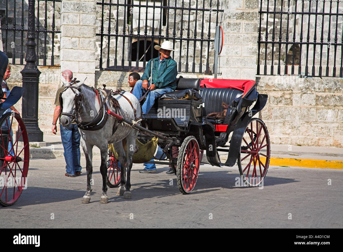 Carriage driver sitting on open top carriage, Plaza de Armas, Havana ...