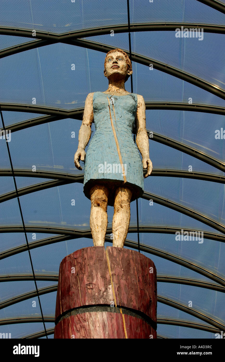 Modern wooden sculpture of woman in shopping mall Berlin Stock Photo ...