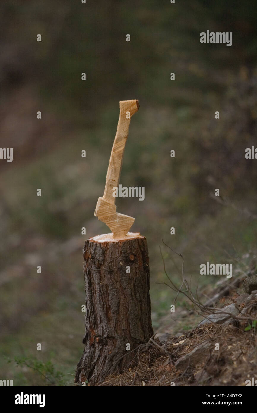 Axe carved in tree stump. South Tyrol, Italy Stock Photo - Alamy
