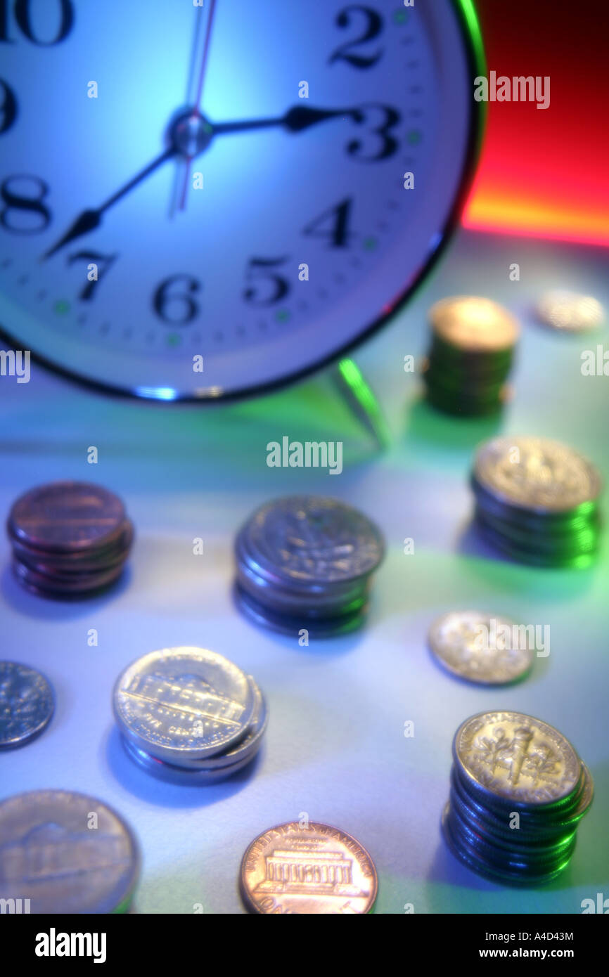 Clock and coins Stock Photo - Alamy