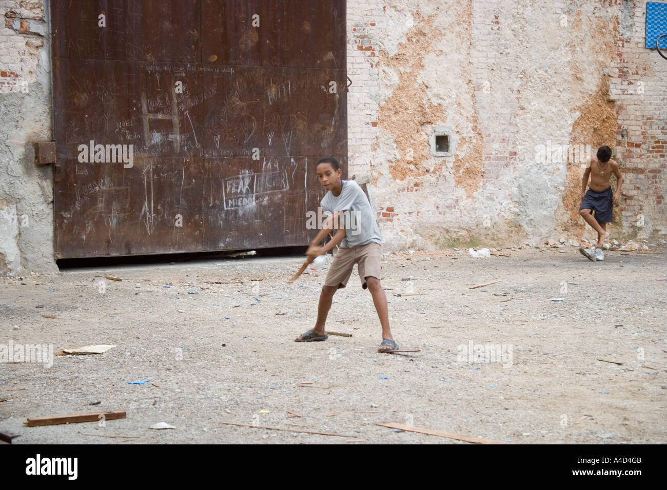 Street Kids playing baseball on some derelict ground in the old town of ...