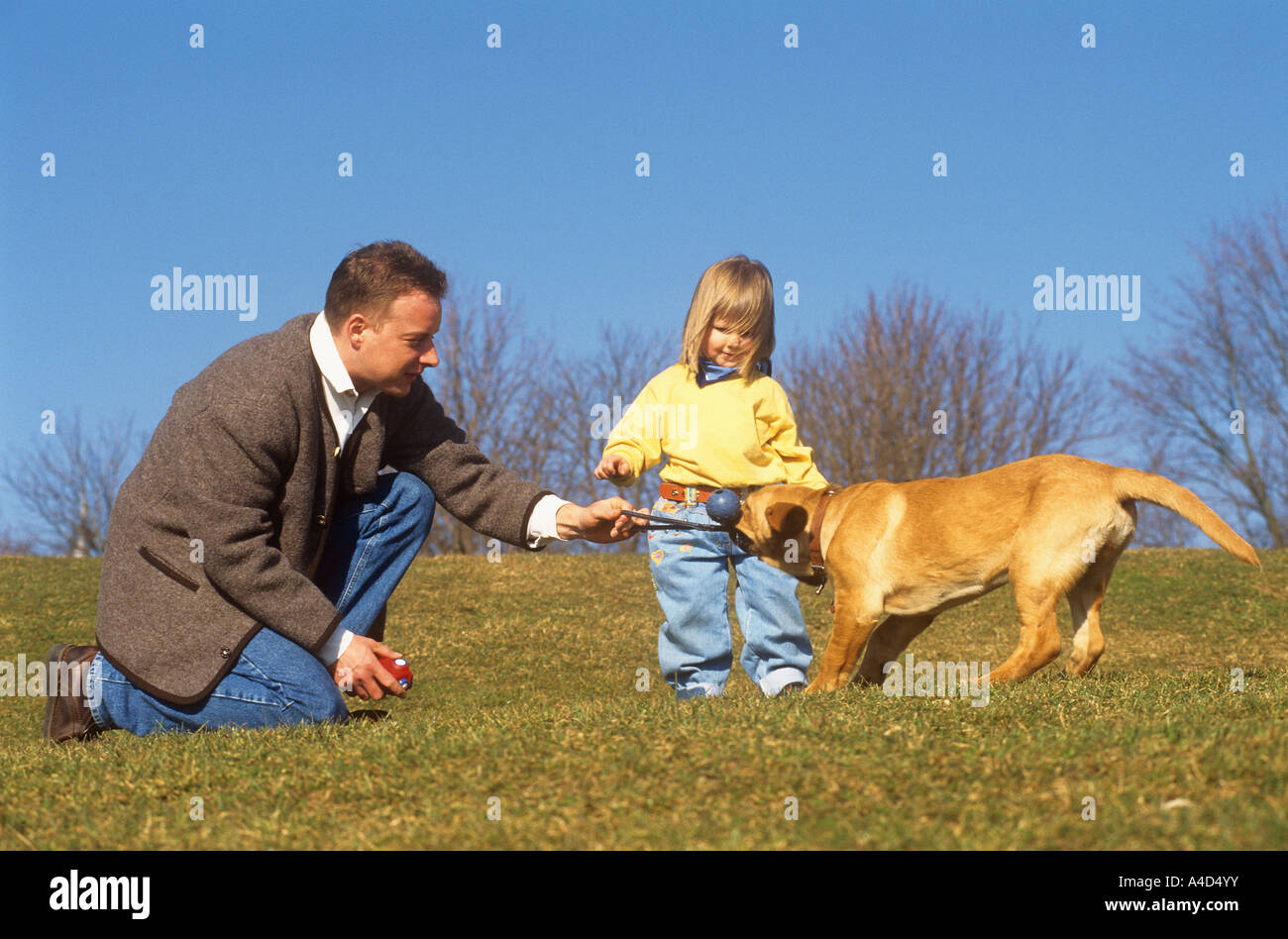 man and child with half breed dog Stock Photo - Alamy