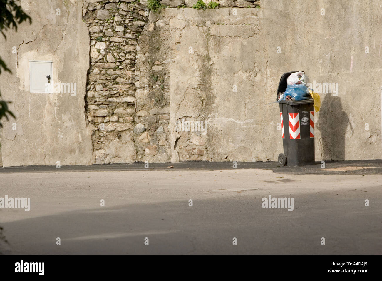 Full garbage bin on the street, Italy Stock Photo - Alamy