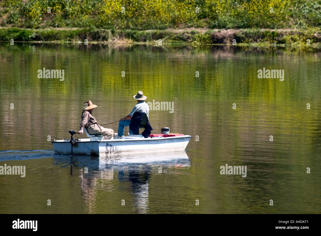 Two old men fishing in a lake Stock Photo - Alamy