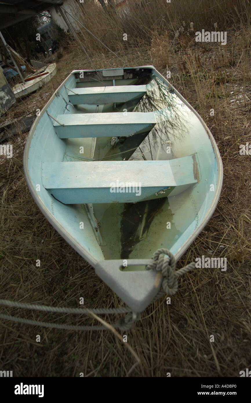 Dingy half full of water Stock Photo - Alamy
