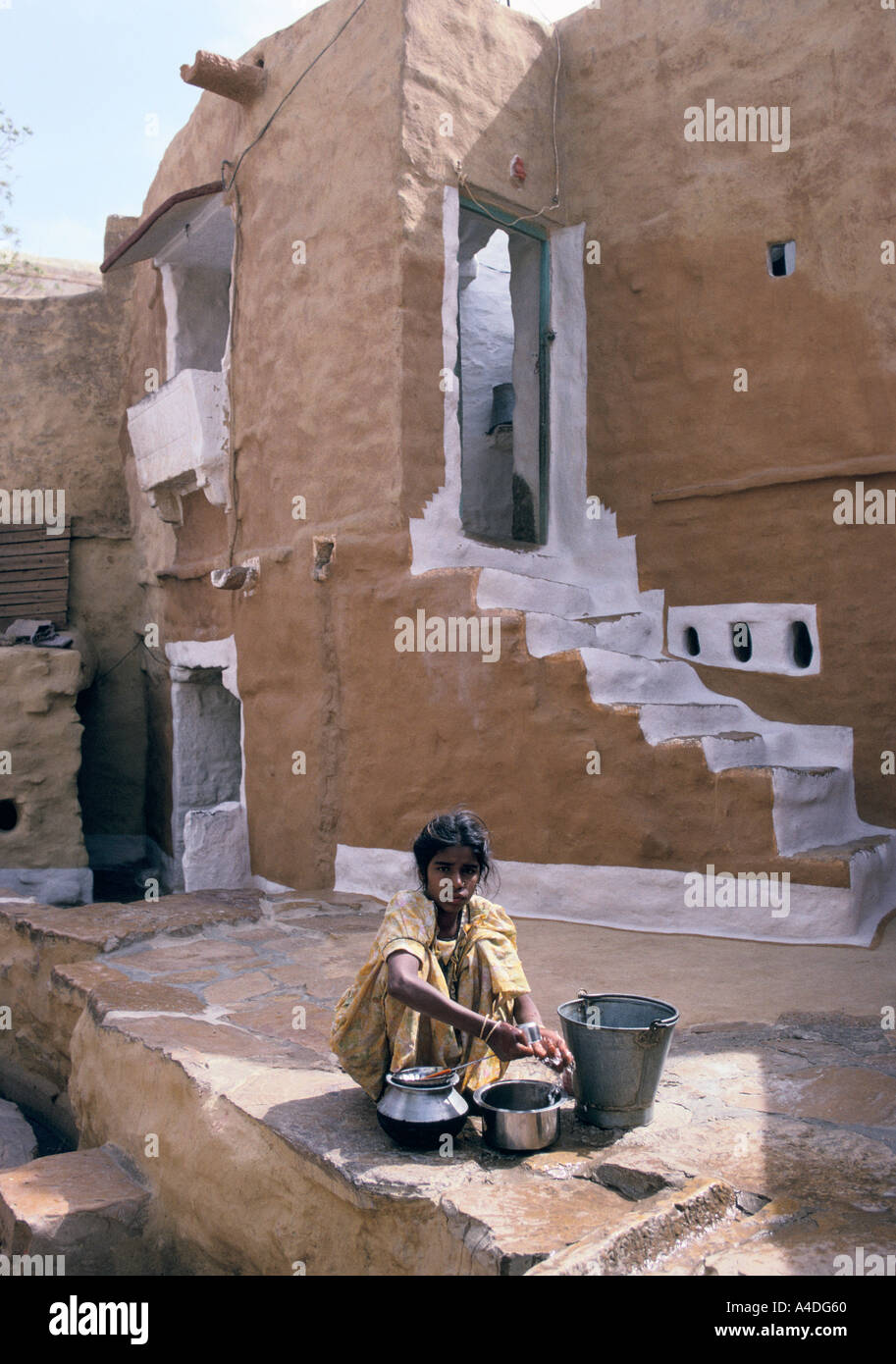 A girl doing washing outside her home. Jaisalmer, Rajasthan, India ...