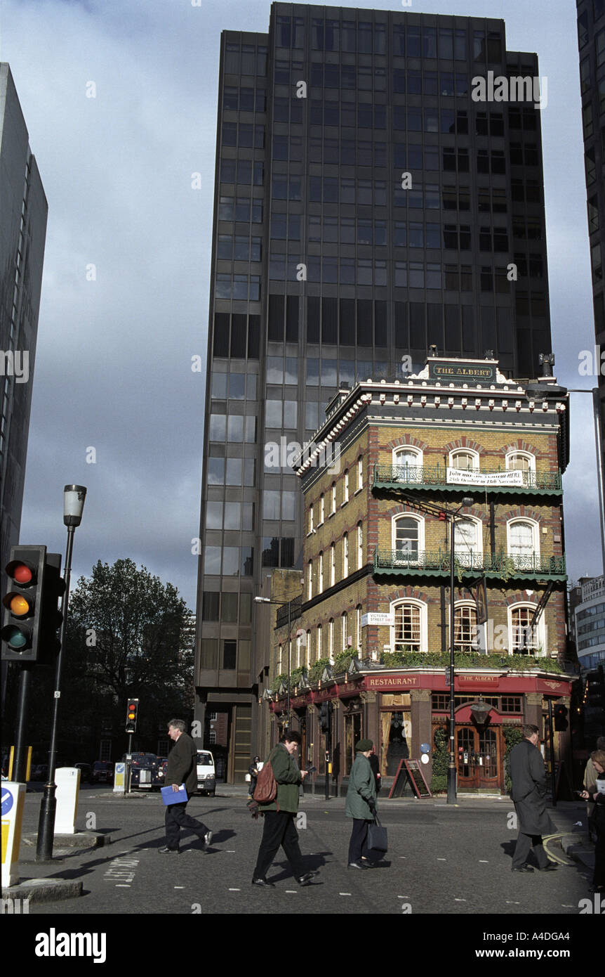 A Victorian pub stands dwarfed in front of a towering office block ...