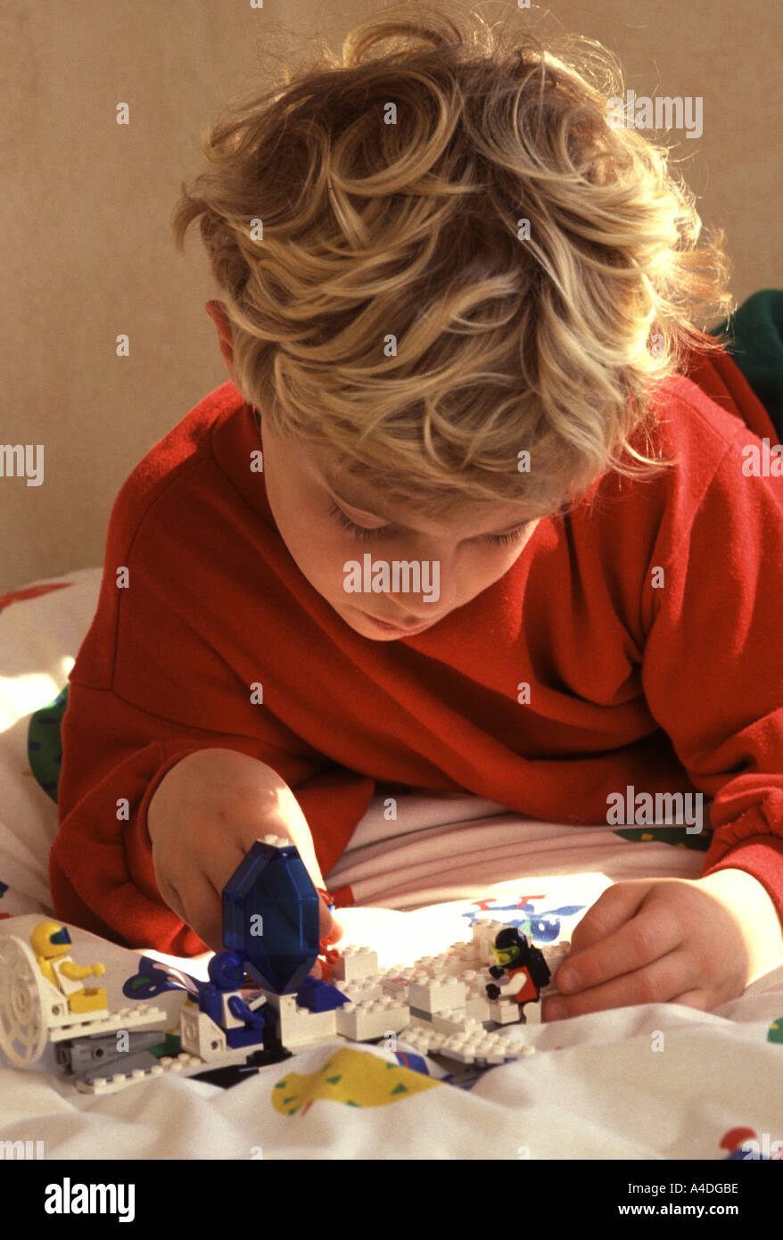 Boy playing with lego Stock Photo - Alamy