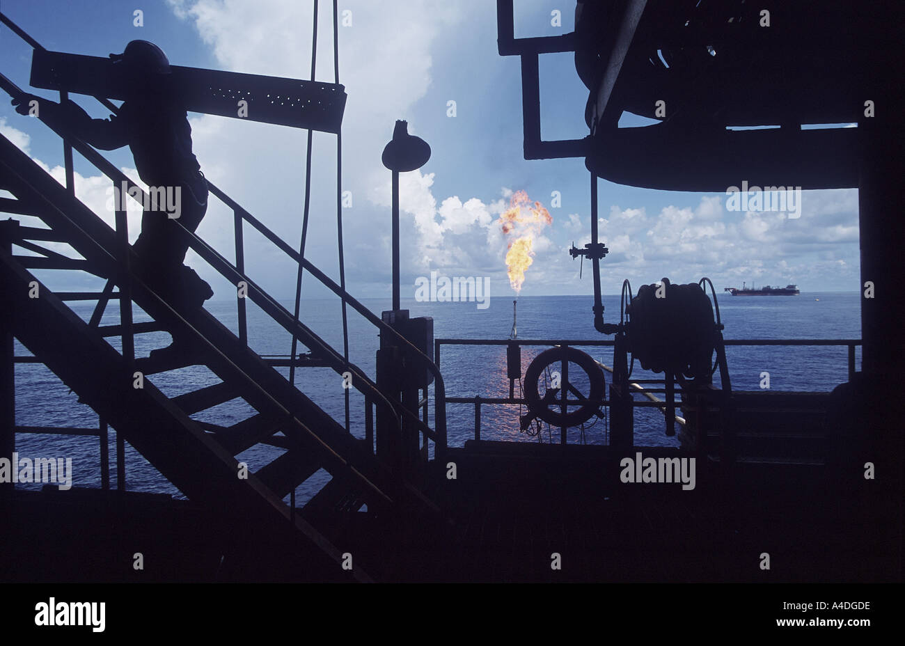 Offshore oil production vessel and rig in background. Indonesia, South ...